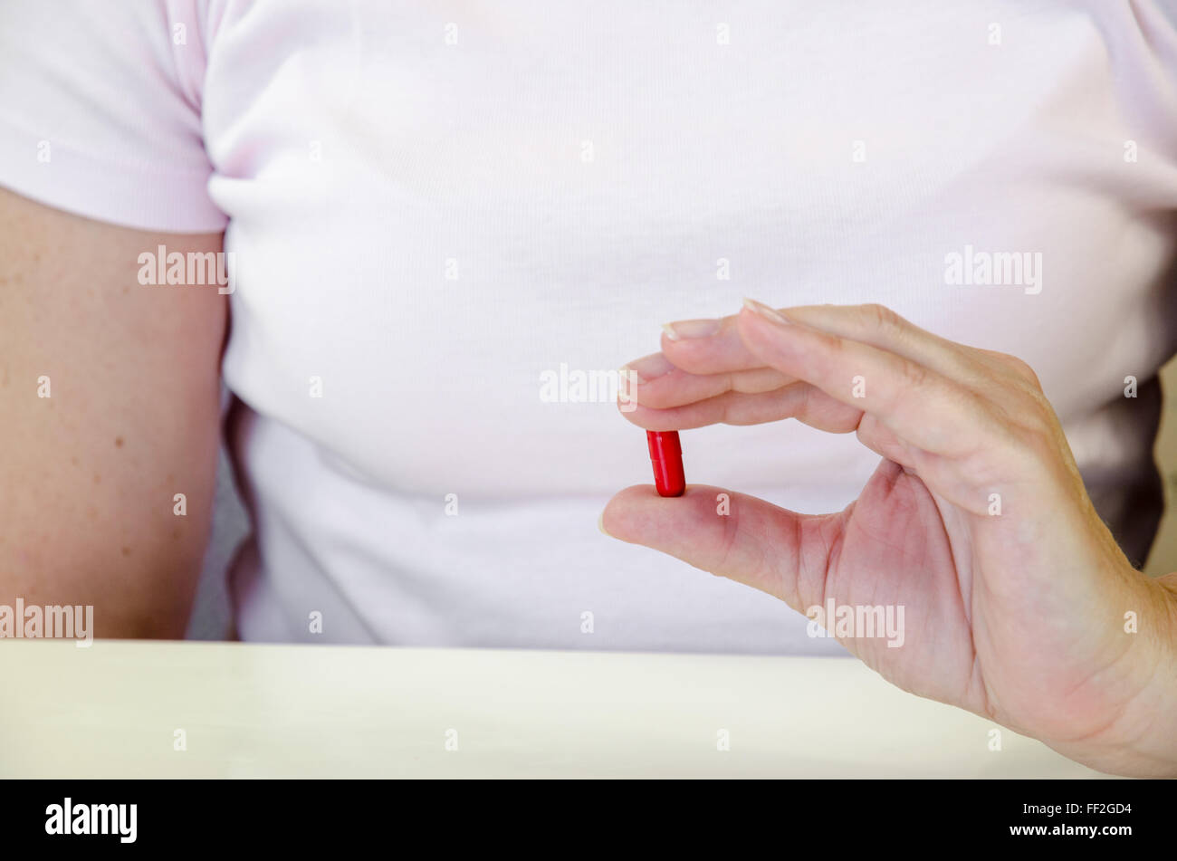 person with one red pill in hand Stock Photo - Alamy