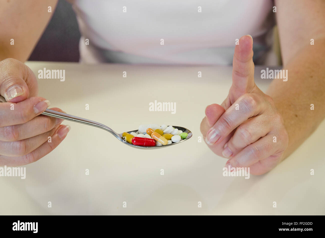 human hand with spoon full of colorful medicals Stock Photo - Alamy