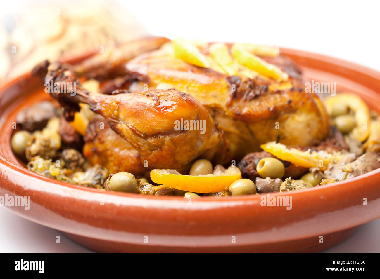 Traditional Moroccan dish with chicken and lemon on white background ...