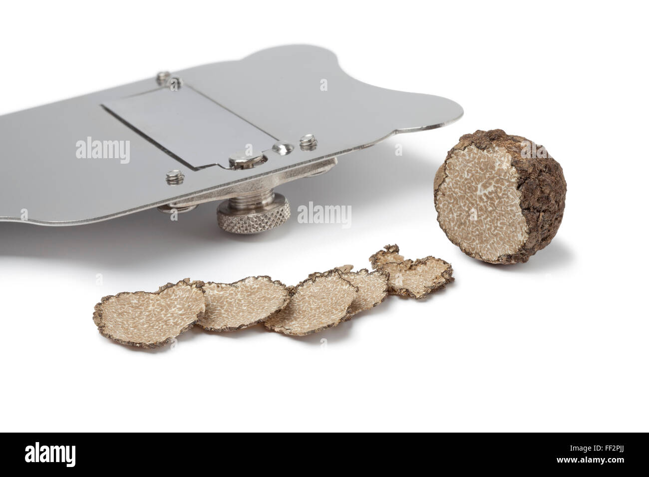 Fresh black winter truffle and slicer on white background Stock Photo ...