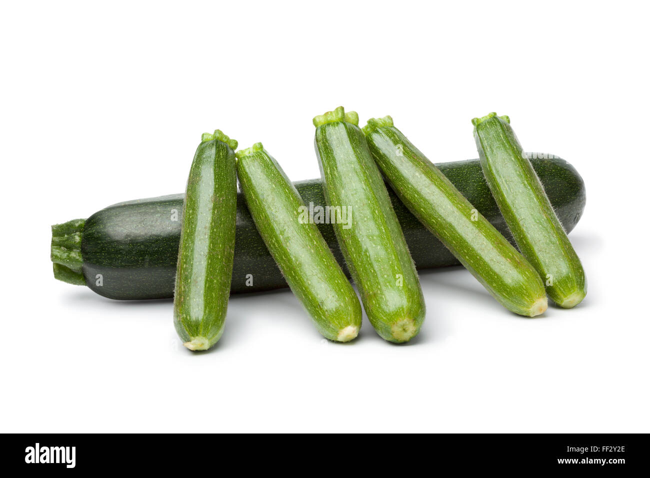 Fresh raw courgette and mini courgettes on white background Stock Photo ...