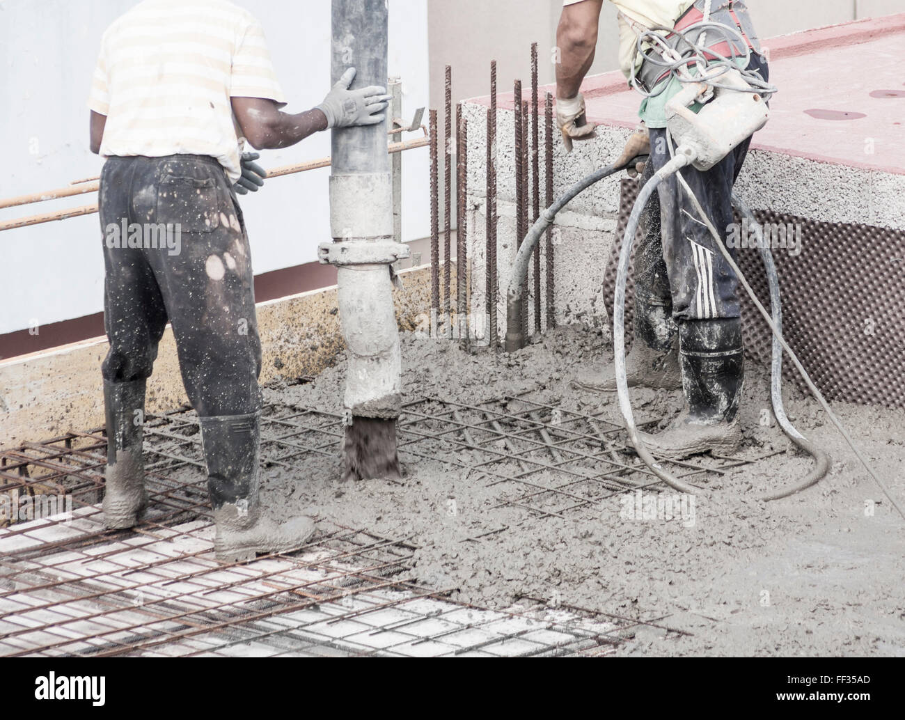Pouring wet concrete, cement on building site Stock Photo - Alamy
