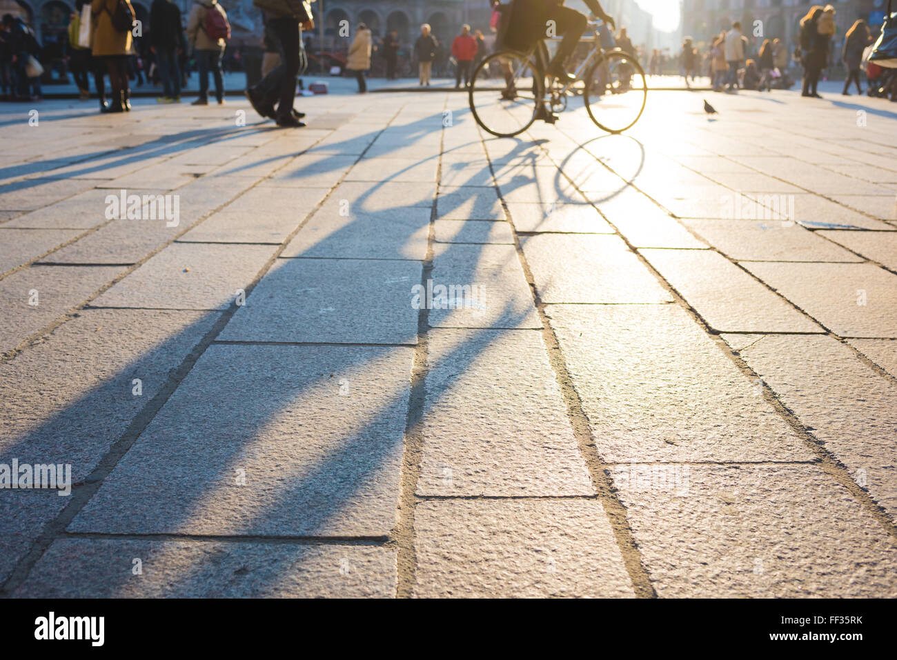 Pedestrian out of focus walking on sidewalk in the city center of a ...