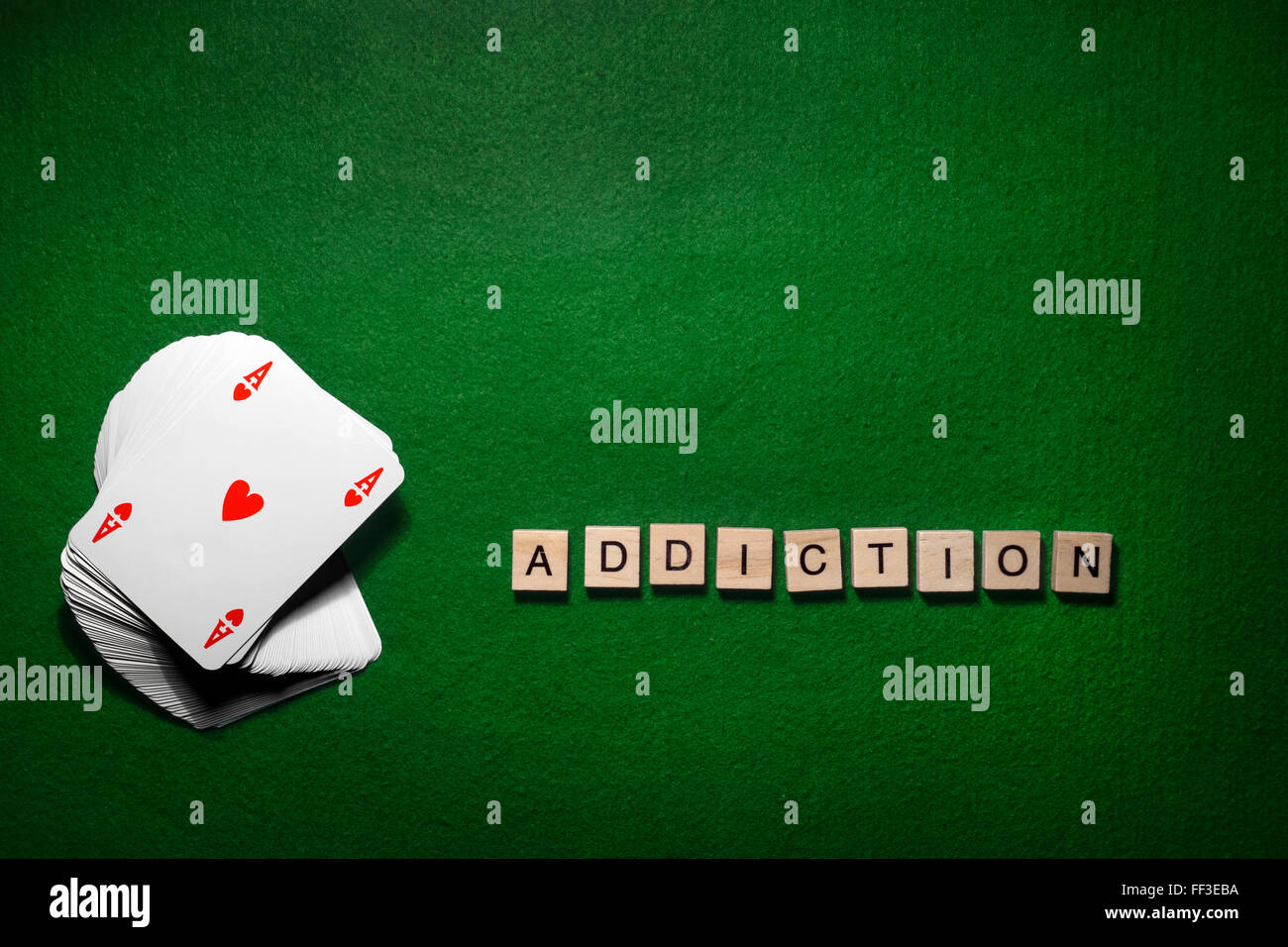 Addiction of playing cards concept isolated on green background Stock ...