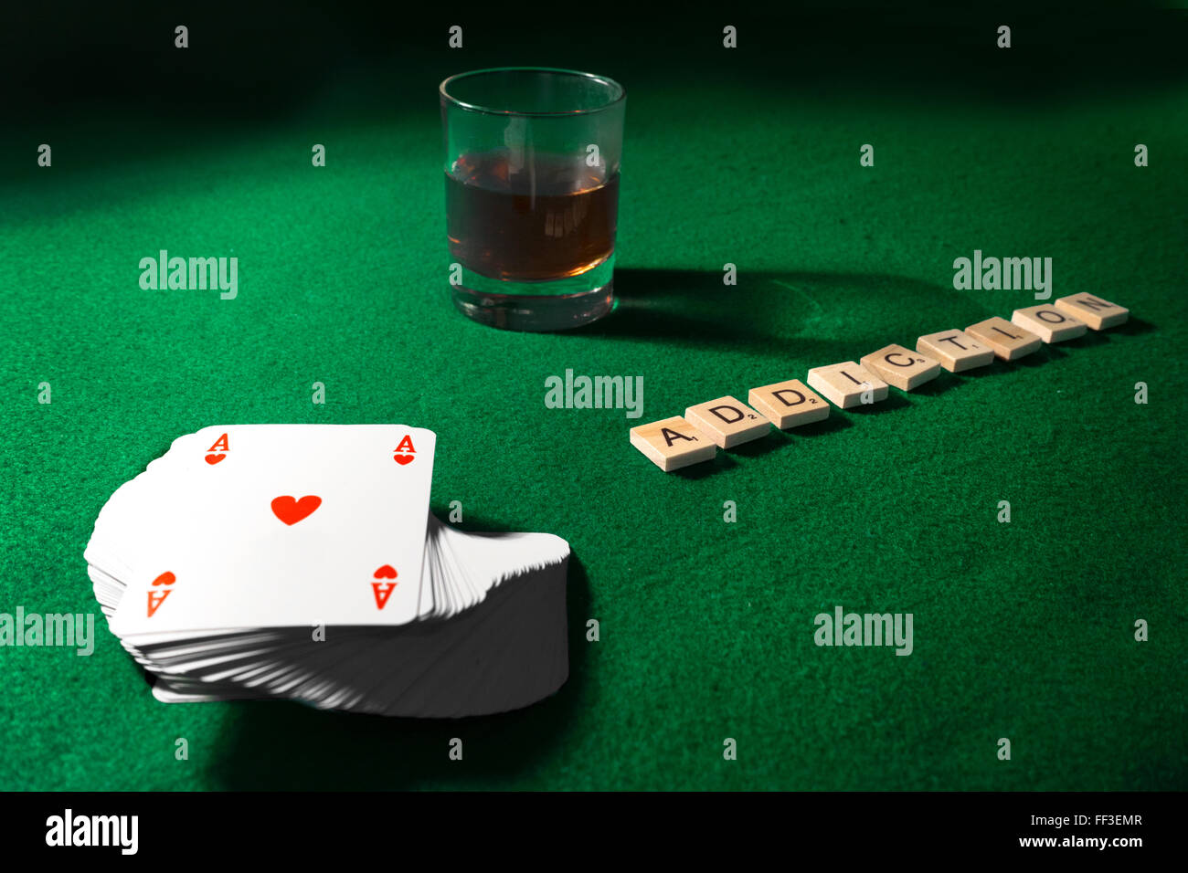 Addiction of playing cards concept isolated on green background Stock ...