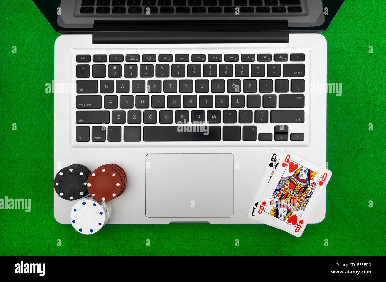Laptop, poker cards and poker chips, on green background.top view Stock ...
