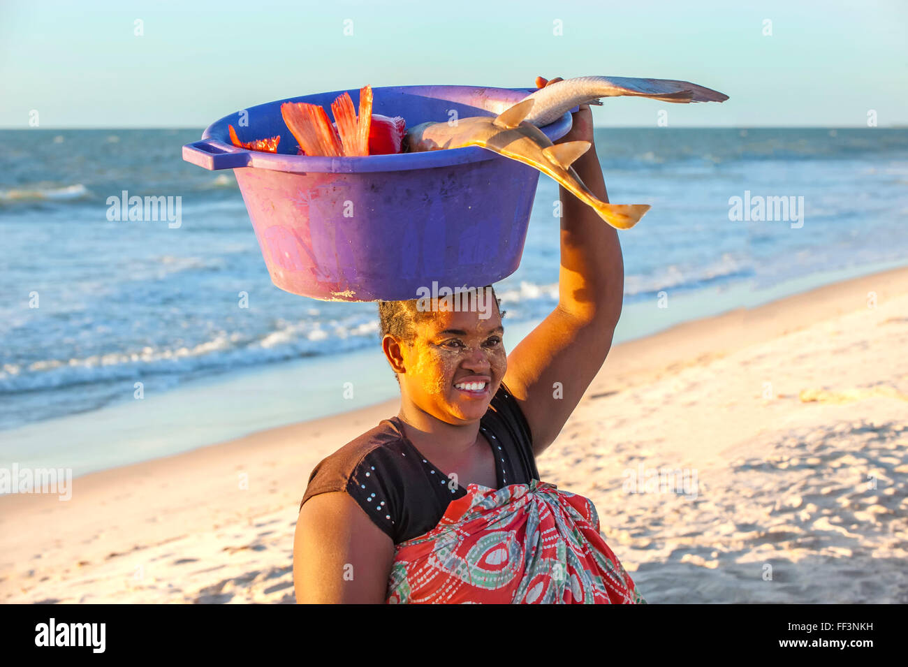 Malagasy woman carrying fish in basin on her head hi-res stock ...