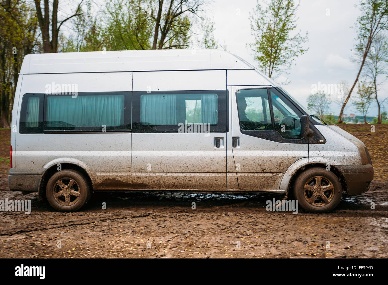 Very Dirty Car Minivan Stalled In Mud Stock Photo - Alamy