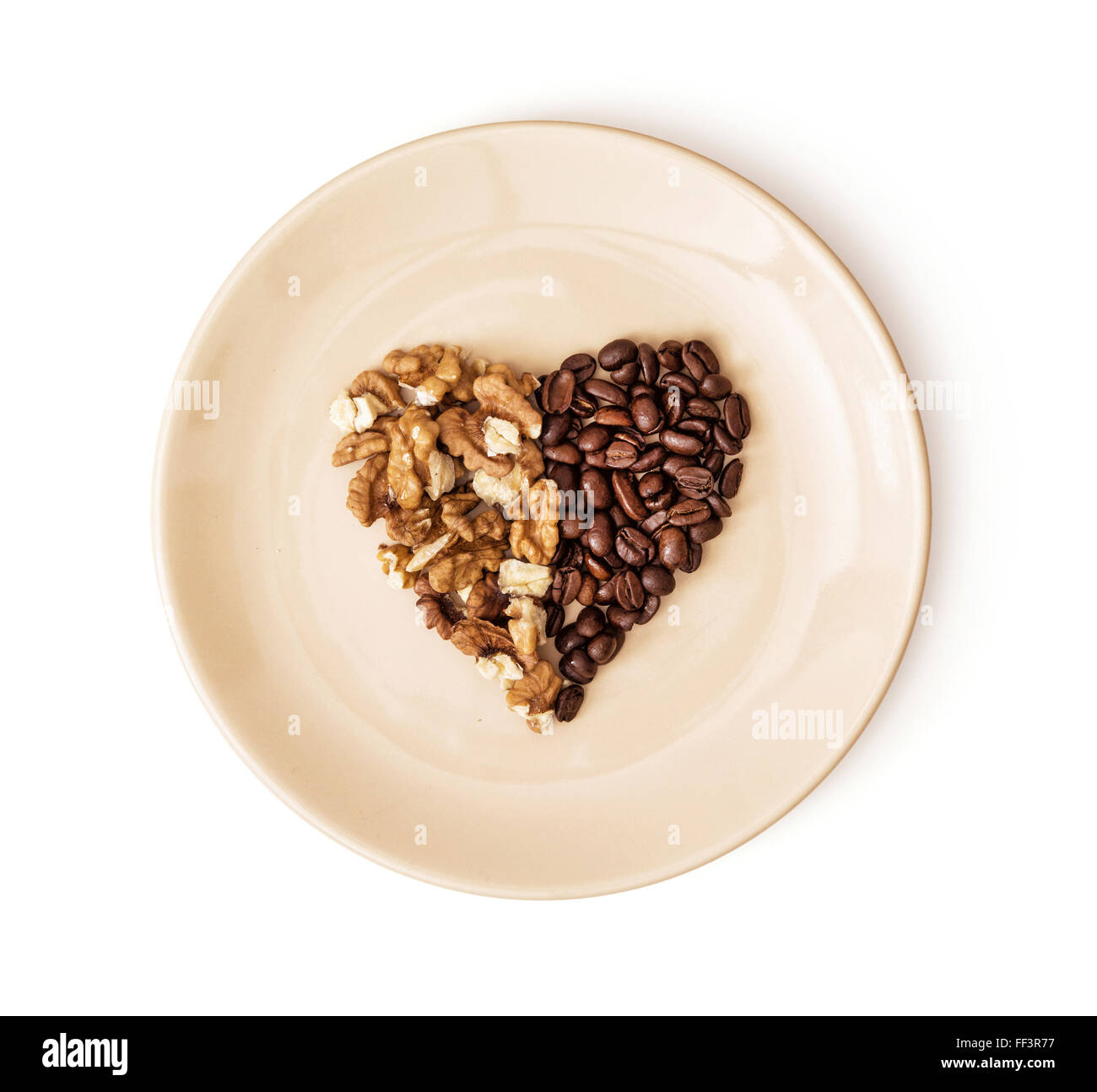 Shape heart of coffee beans and peeled walnuts on the plate. Valentine ...