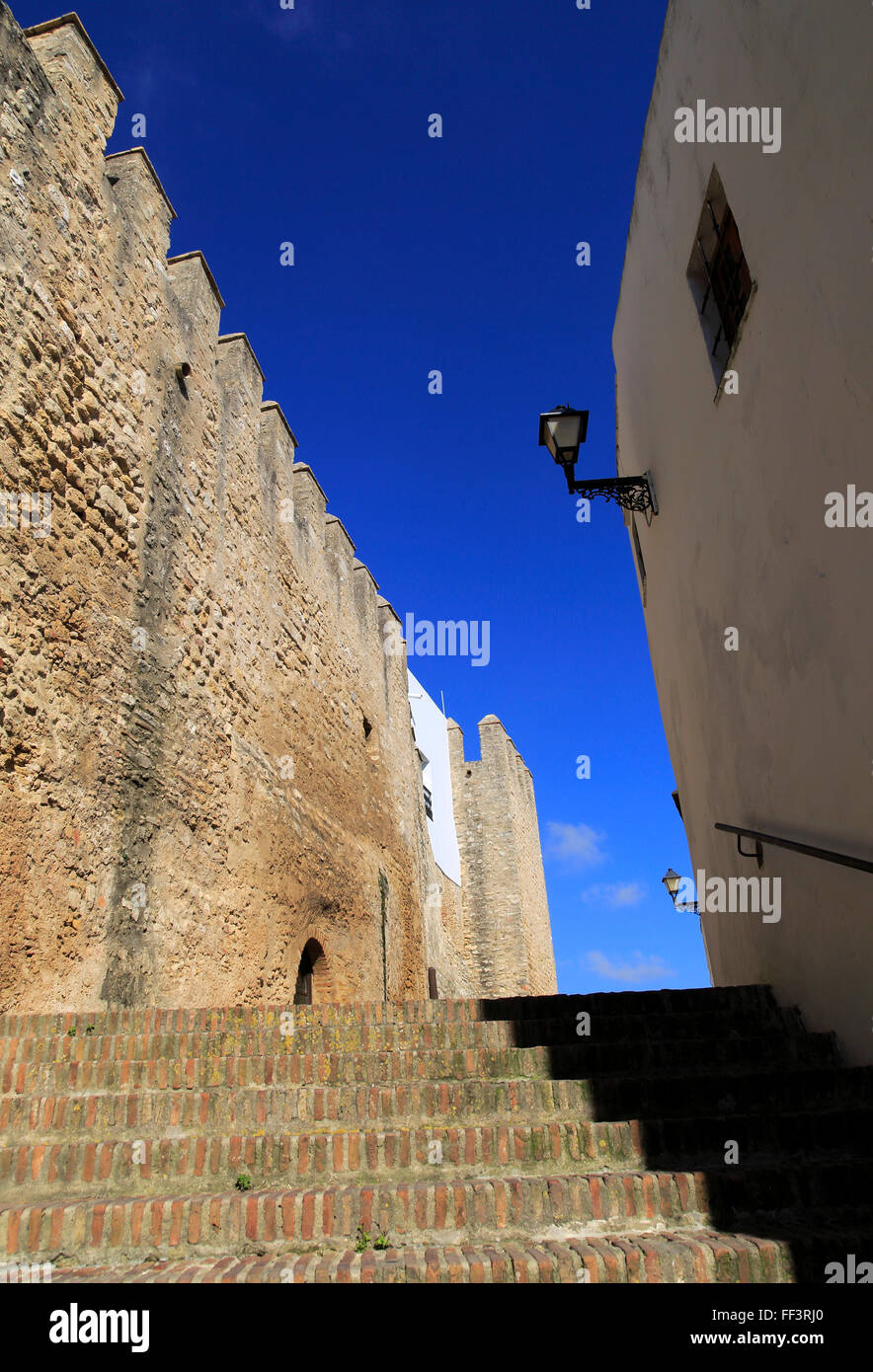 Historic street and castle walls in the village of Vejer de la Frontera ...