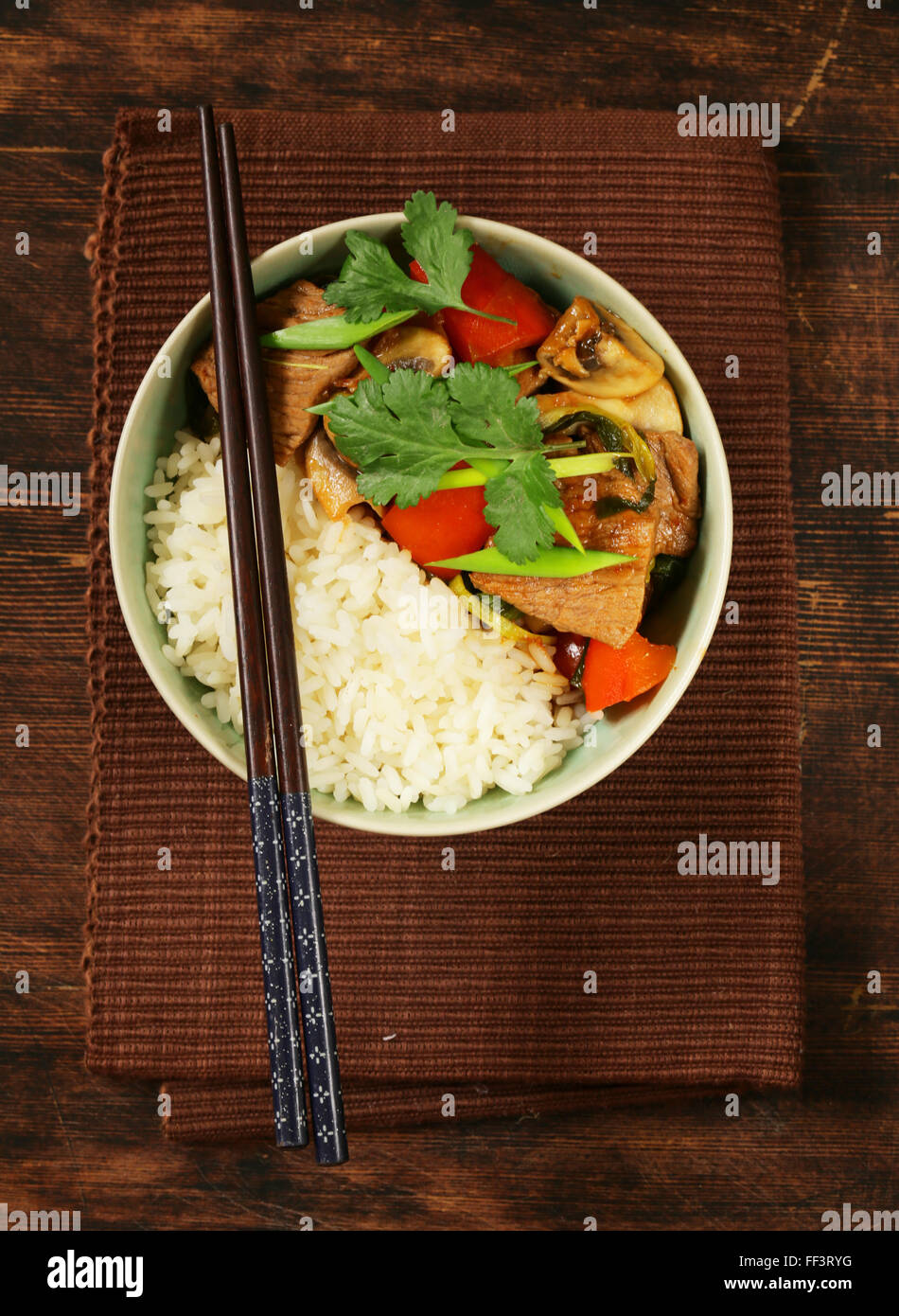 Traditional Asian food - white rice and meat with vegetables in soy ...