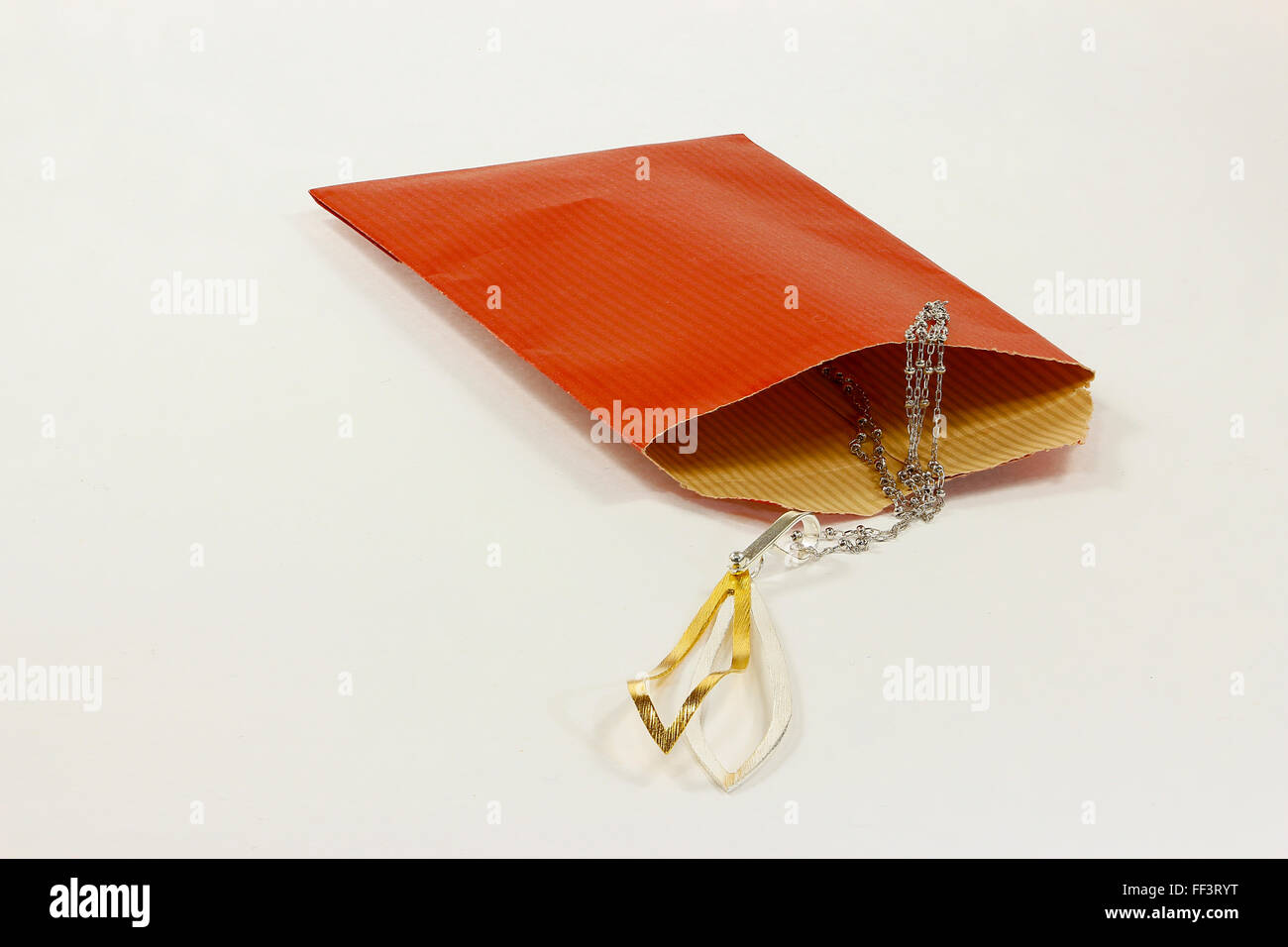 Golden necklace and a red envelope Stock Photo - Alamy