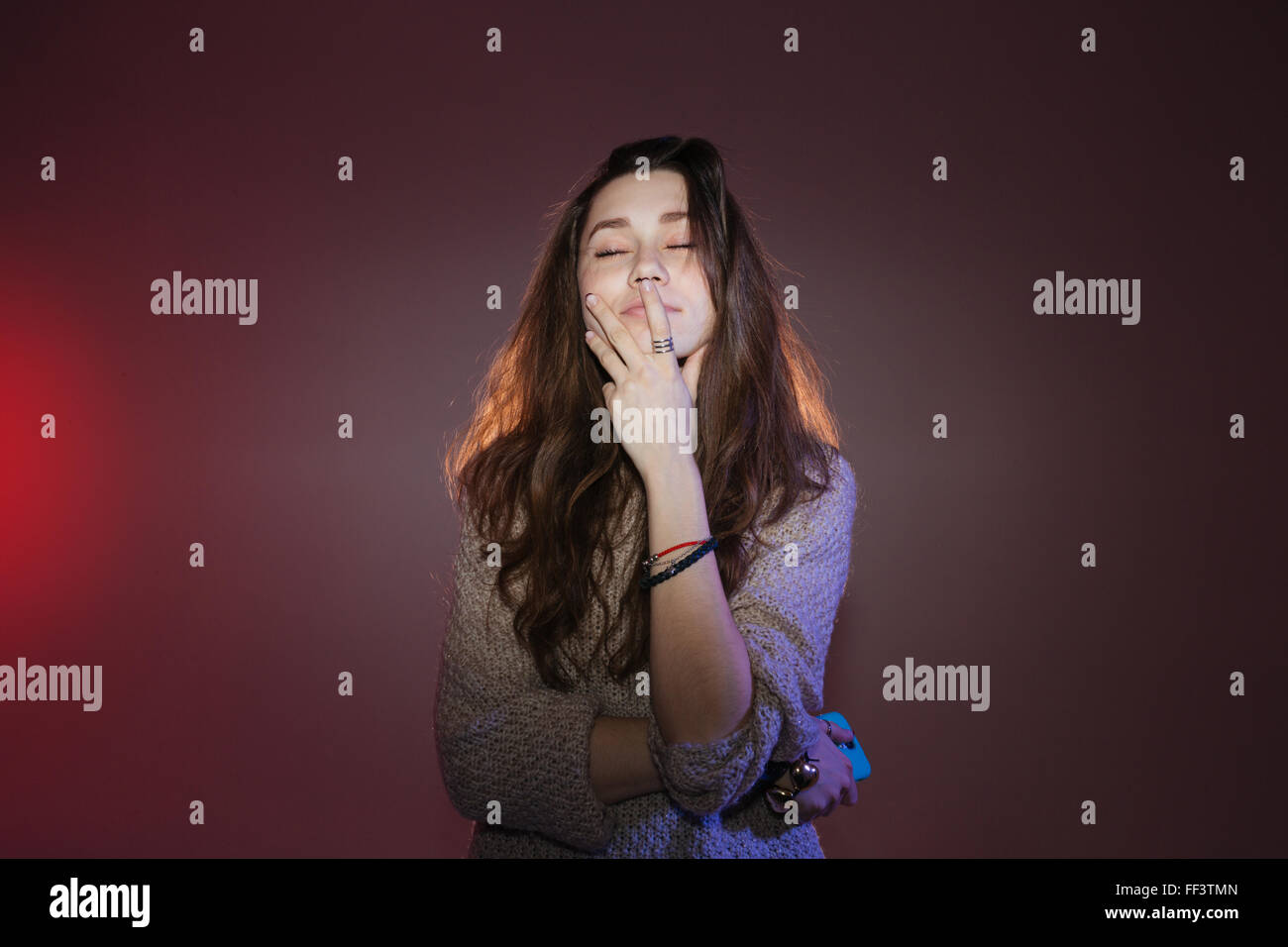 Drug addicted young woman standing with eyes closed over colorful ...