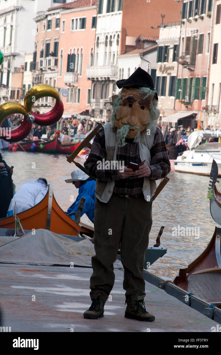 Carnival character taking a call on his mobile Venice carnival opening ...