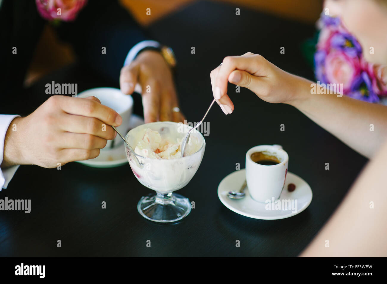 Groom and bride are drinking red tea outdoors Stock Photo - Alamy