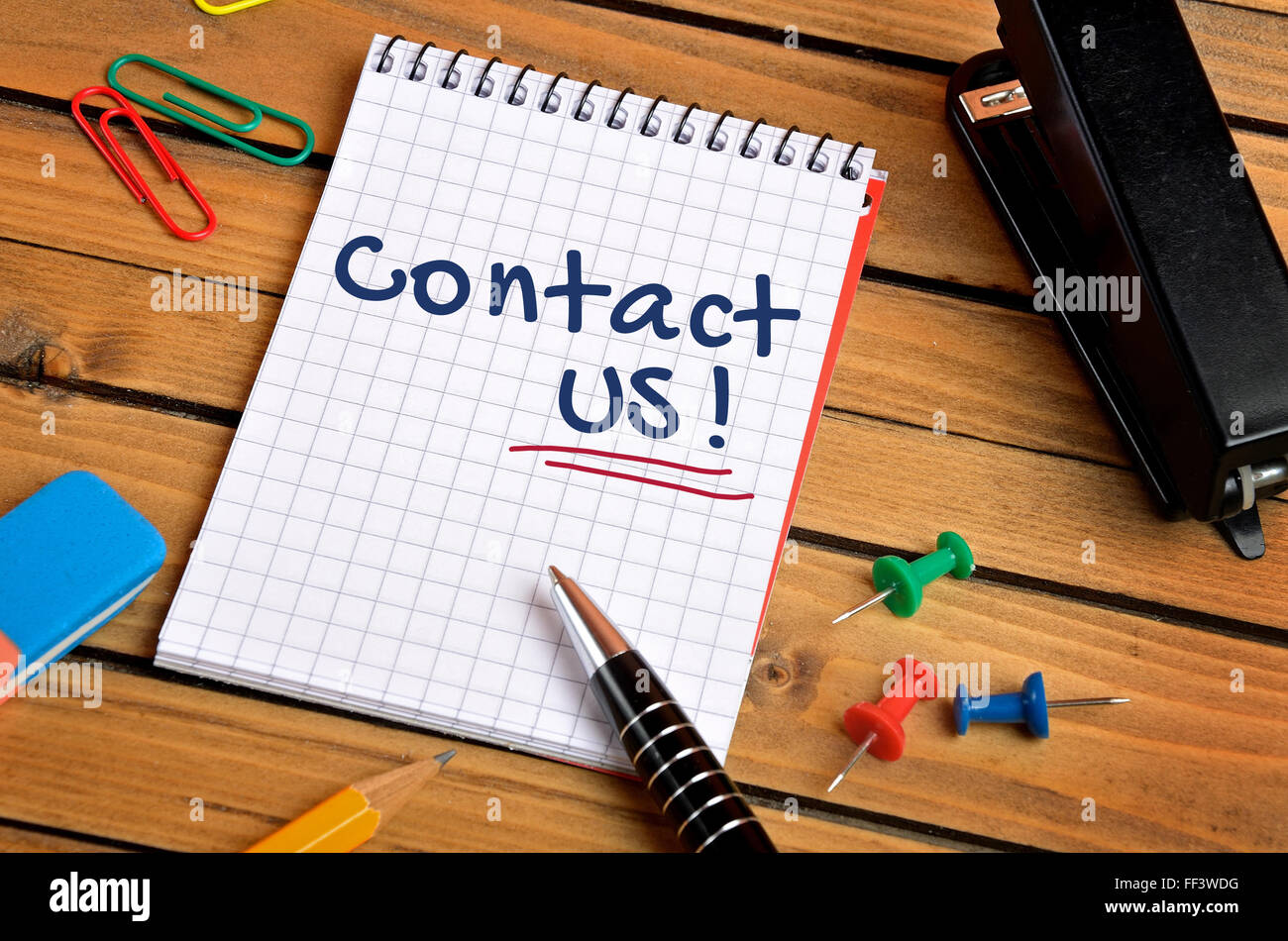 Contact us word on notepad Stock Photo - Alamy