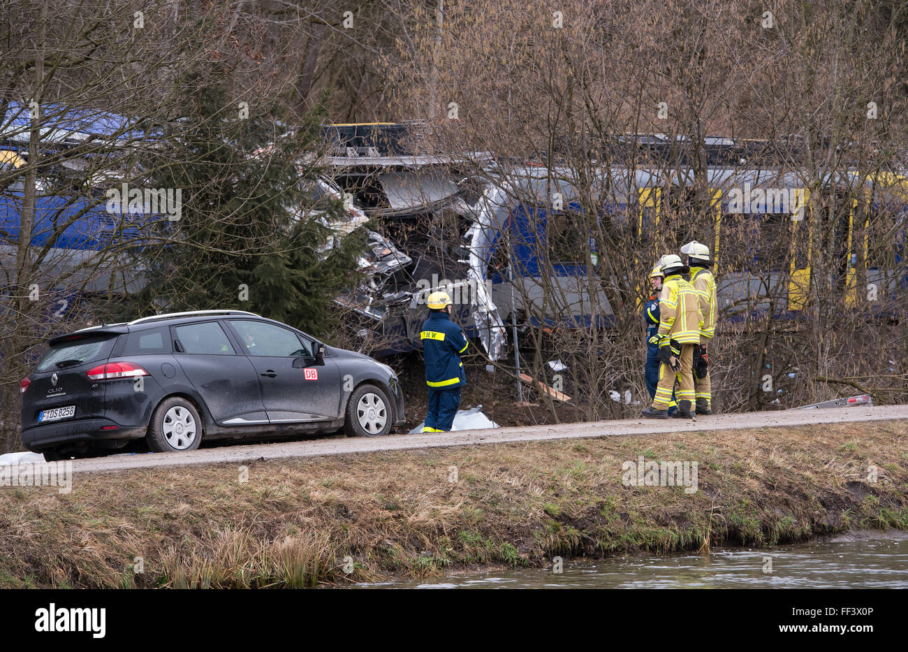 Bad Aibling, Germany. 10th Feb, 2016. Firefighters stand at the site of ...