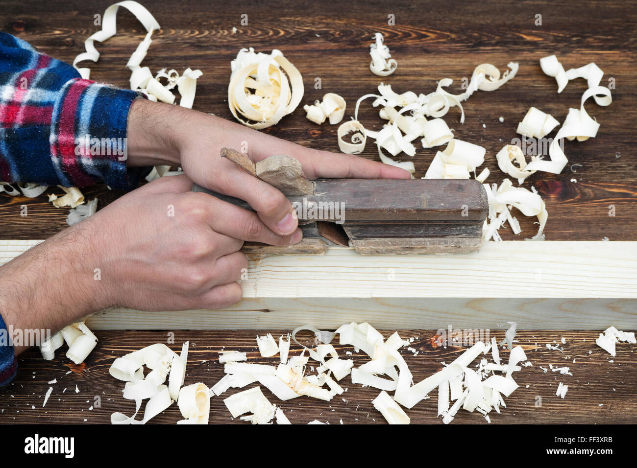 Hands of a carpenter planed wood Stock Photo - Alamy