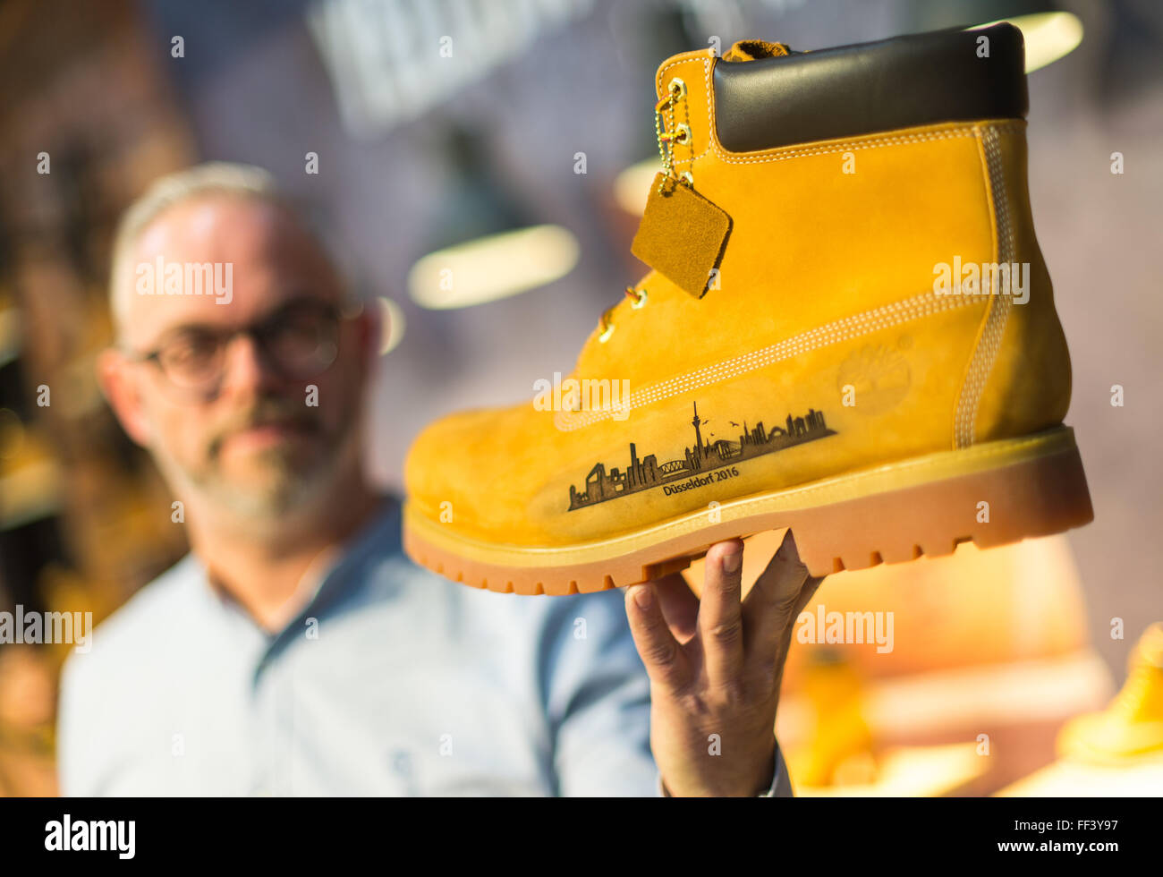 Duesseldorf, Germany. 10th Feb, 2016. A Timberland employee holds up a ...