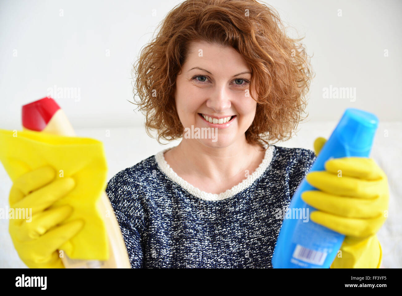 happy woman in rubber gloves with cleaning agents Stock Photo - Alamy