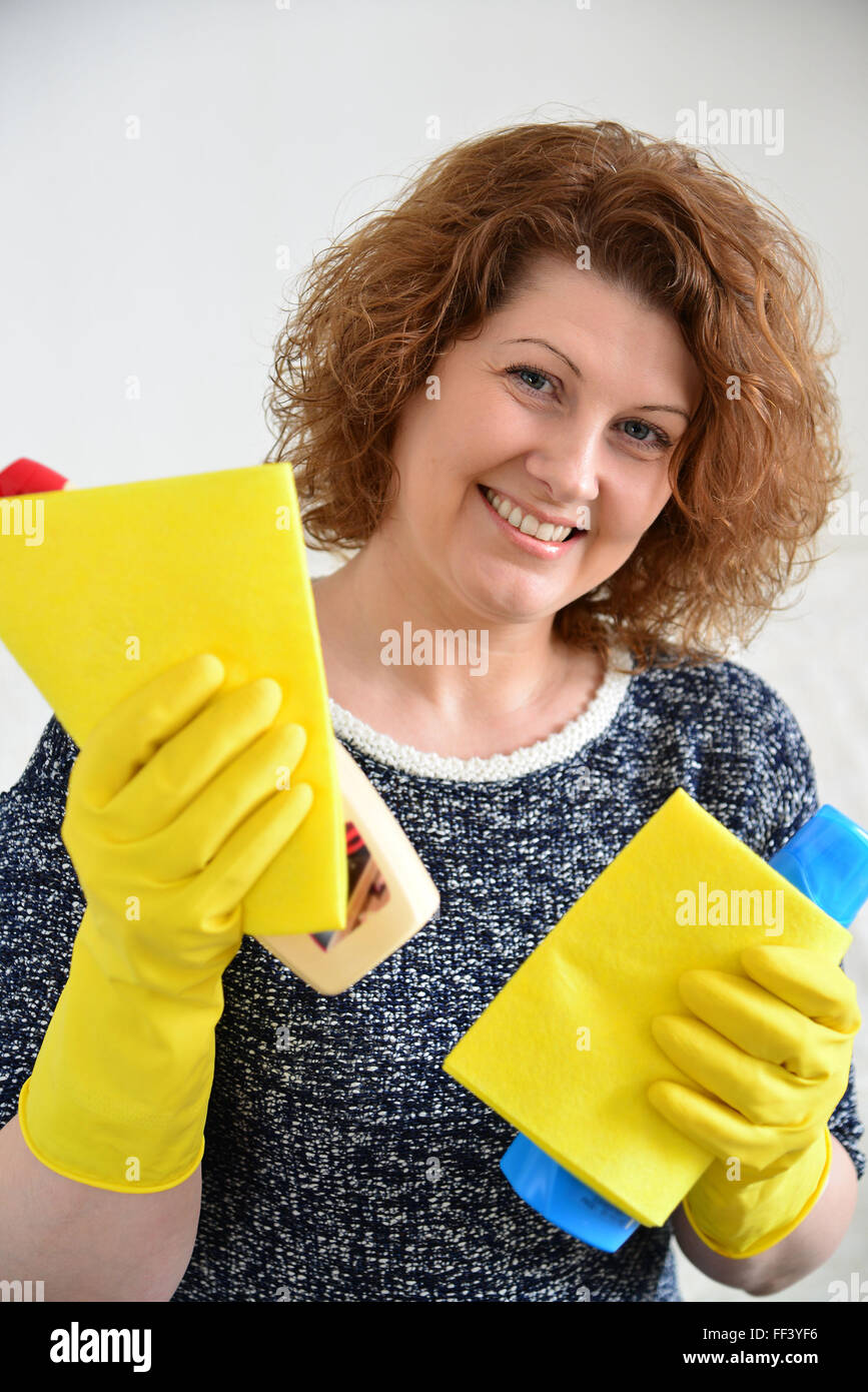 happy woman in rubber gloves with cleaning agents Stock Photo - Alamy