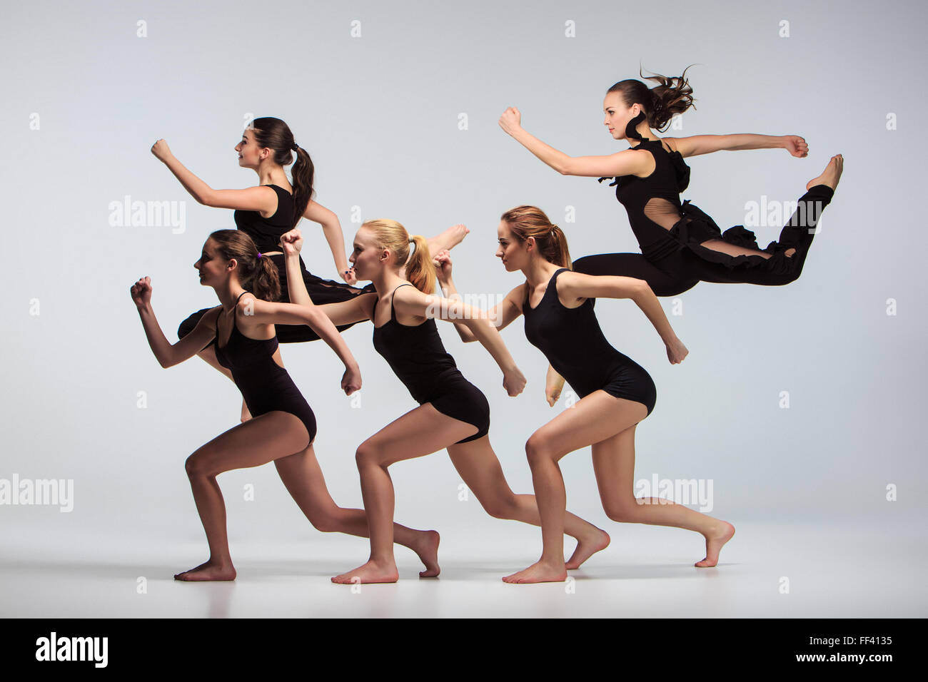 The group of modern ballet dancers dancing on gray background Stock ...