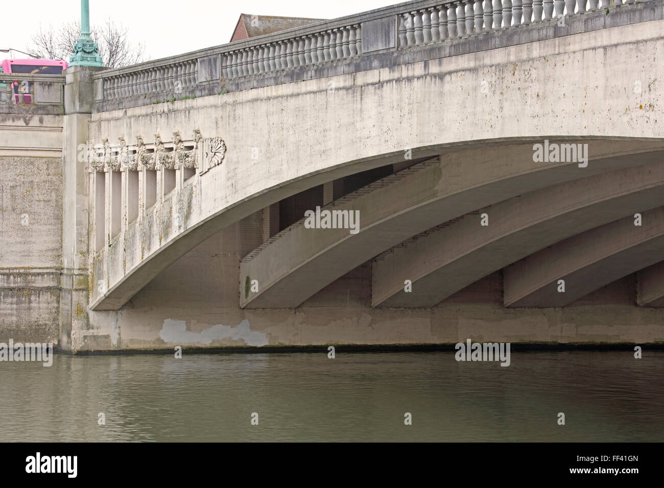 Looking across the river at a corner of the concrete bridge with the ...