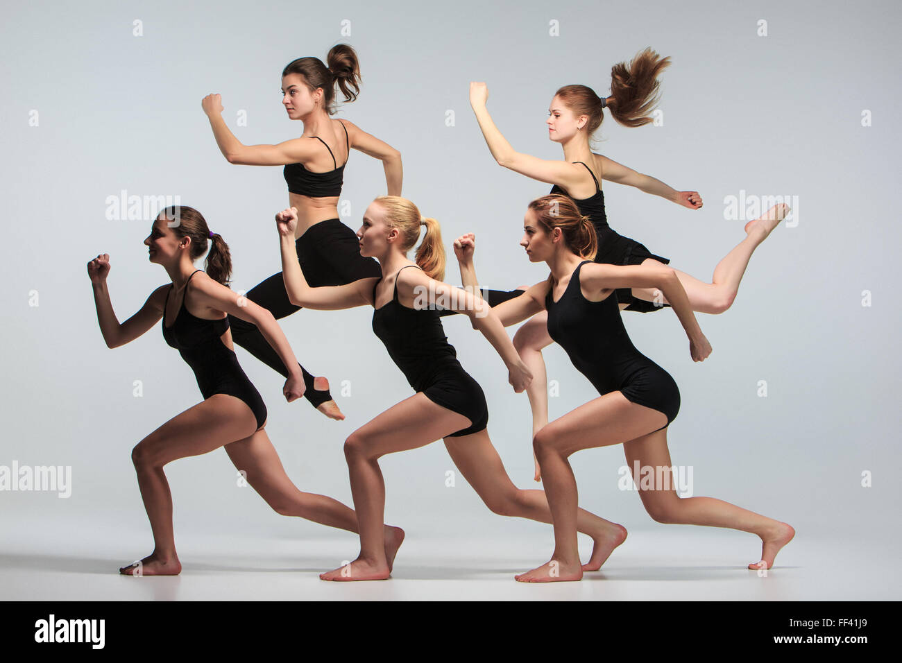 The group of modern ballet dancers dancing on gray background Stock ...