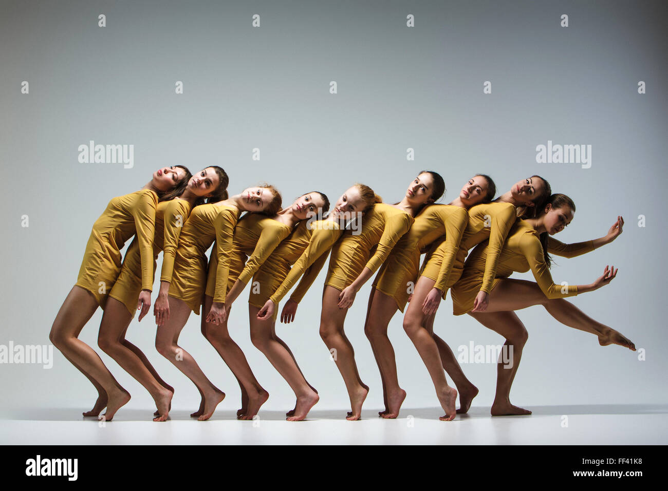 The group of modern ballet dancers dancing on gray background Stock ...