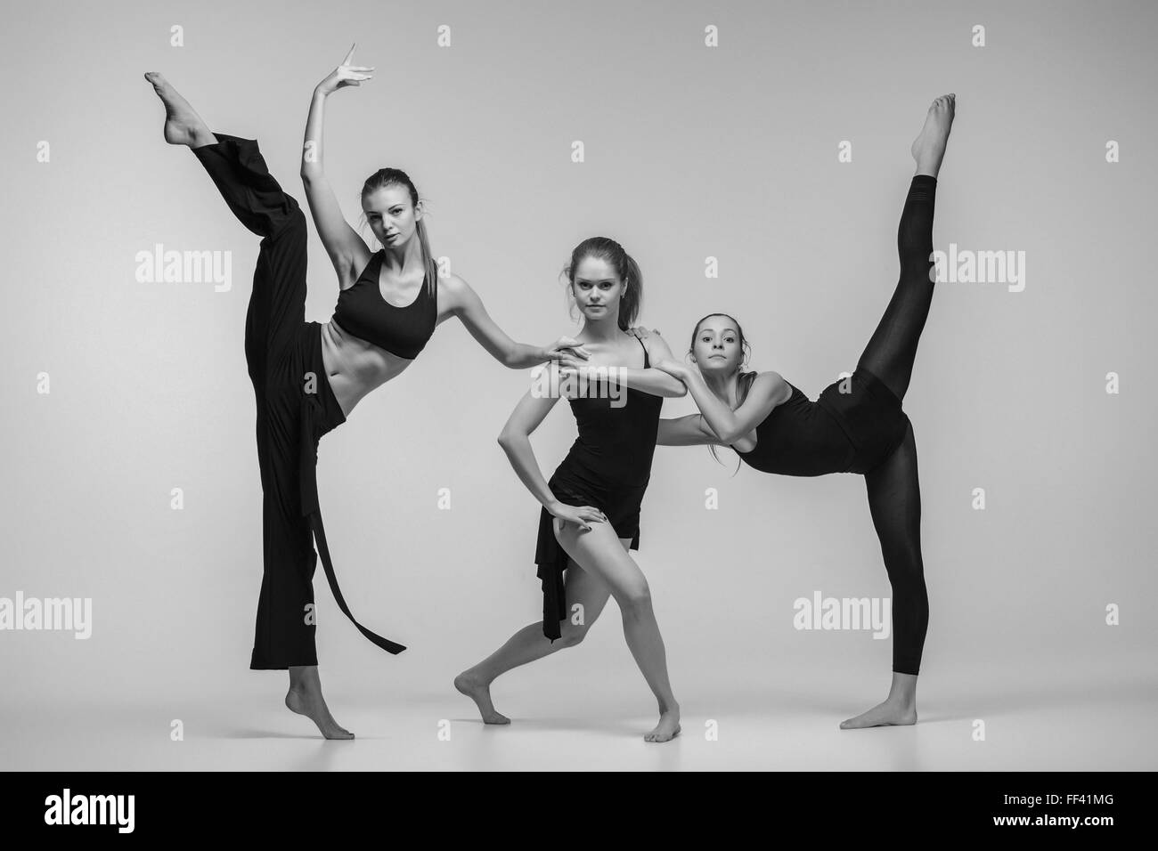 The group of modern ballet dancers dancing on gray background. The ...