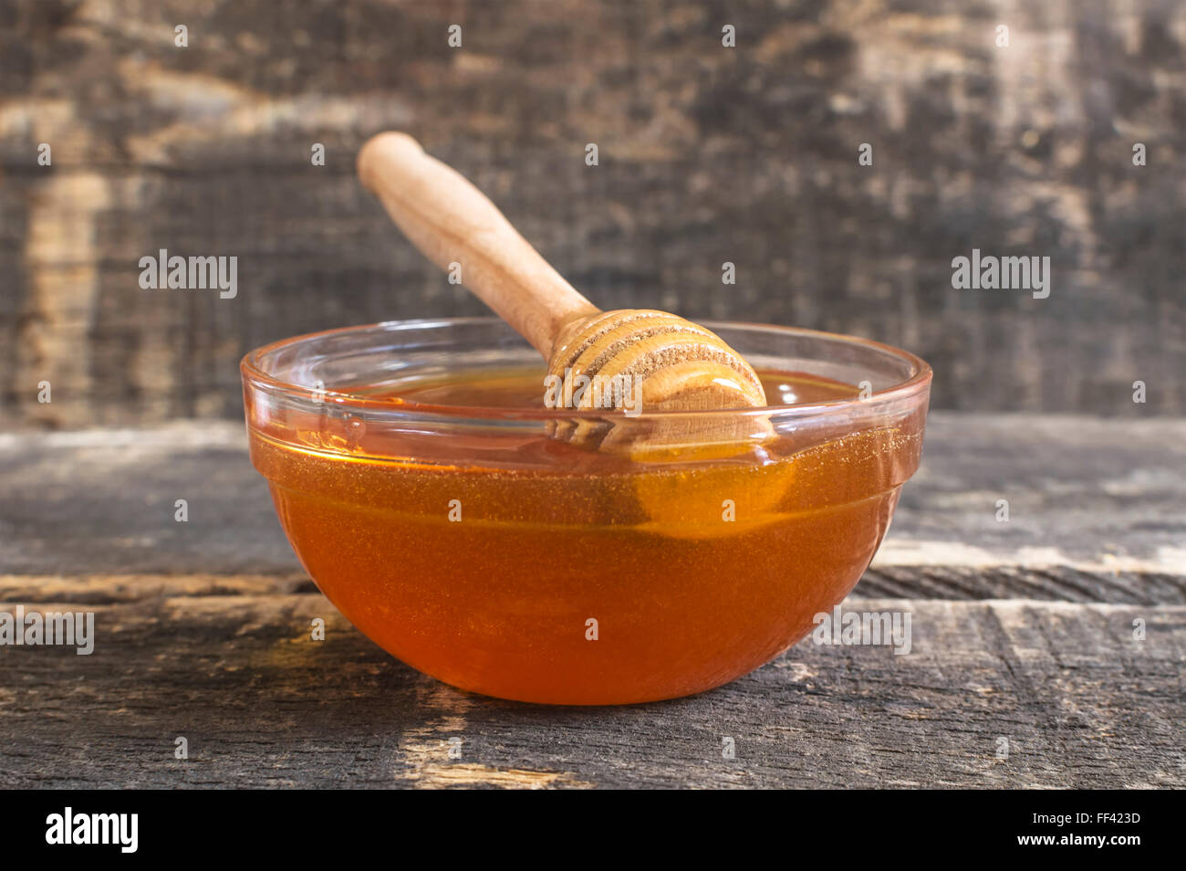 Fresh natural honey in a jar with honey spoon on a wooden rustic ...