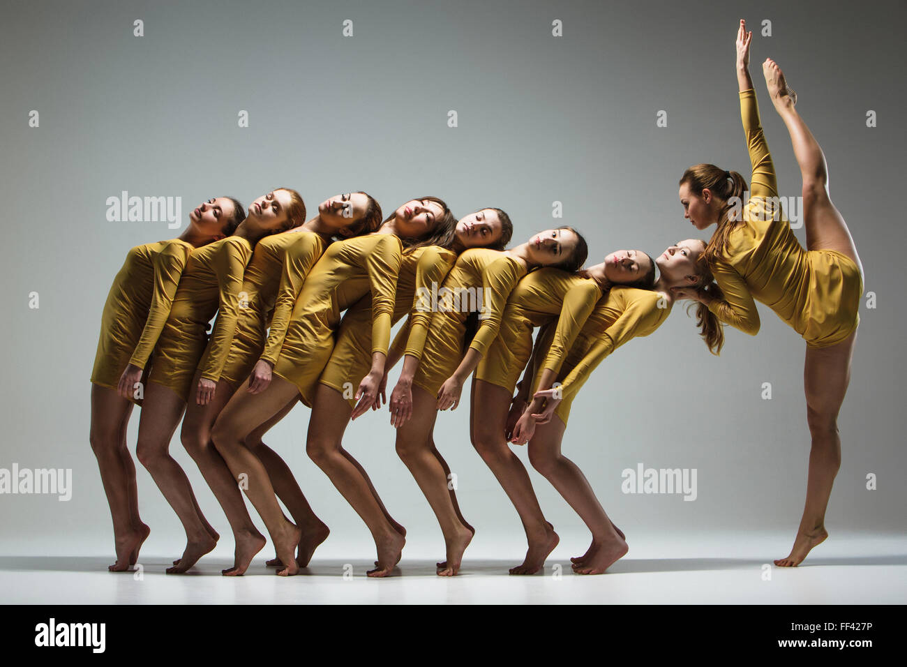 The group of modern ballet dancers dancing on gray background Stock Photo - Alamy