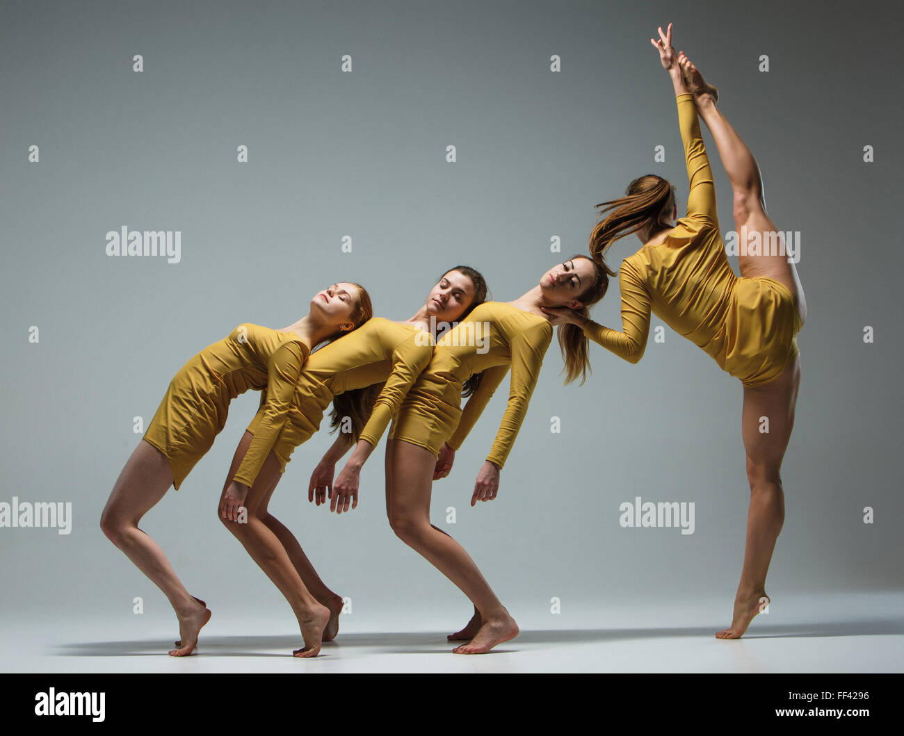 The group of modern ballet dancers dancing on gray background Stock ...