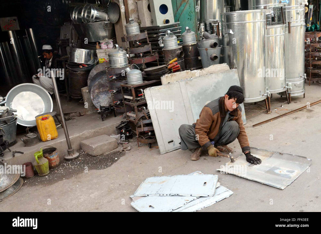 Labour busies in his work at his shop to earn his livelihood for ...