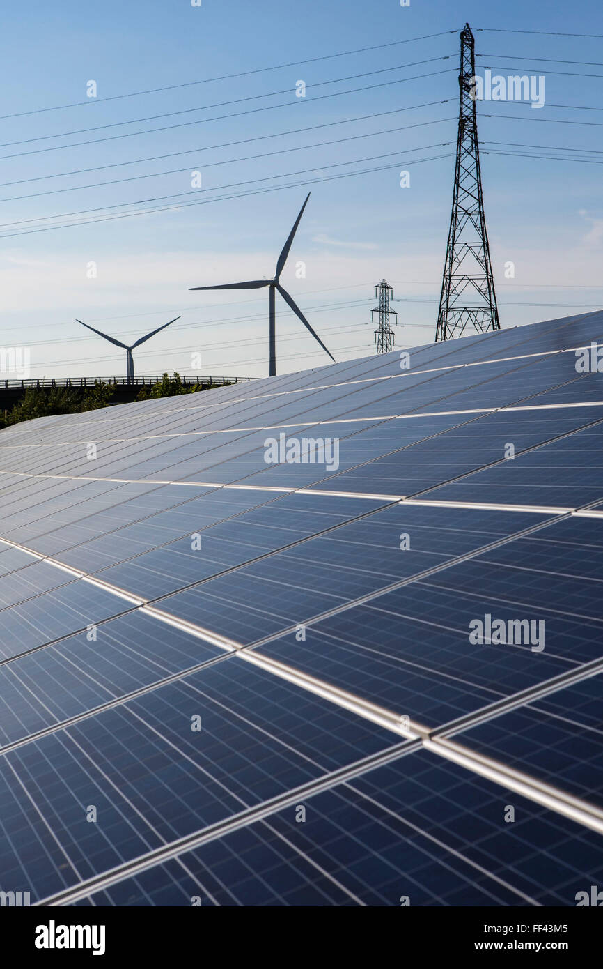 Solar panels, wind turbines and electricity pylons at the Solar array ...