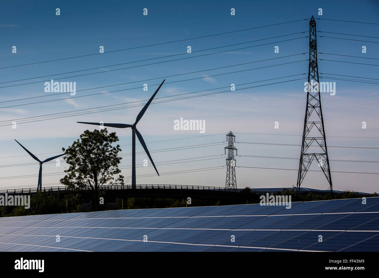 Solar panels, wind turbines and electricity pylons at the Solar array ...