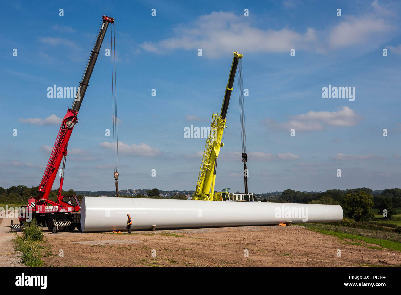Wind turbine installation. A workman secure the crane fixtures ready to ...