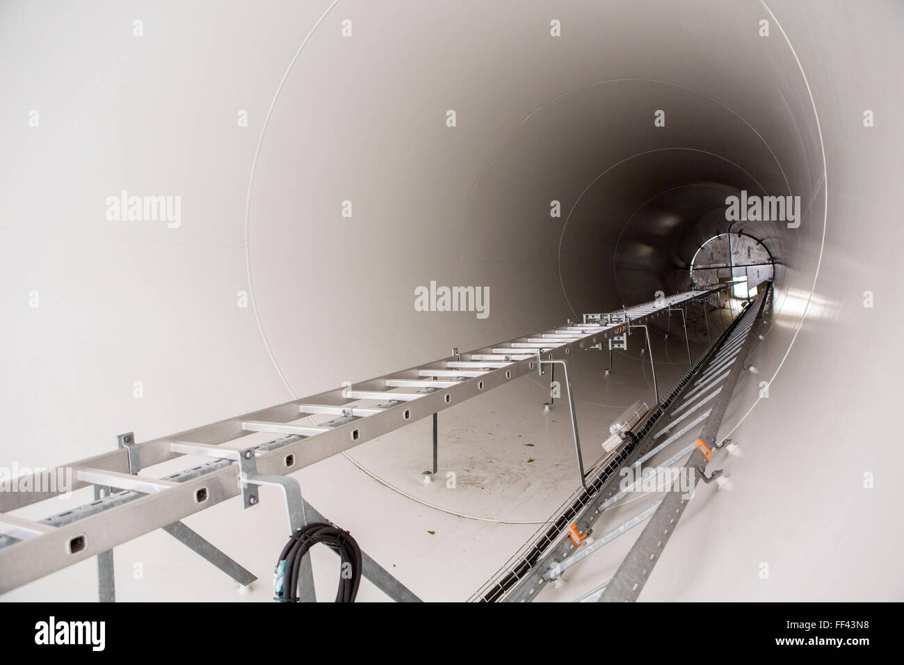 Wind turbine installation. The view up the ladder inside the shaft of a ...