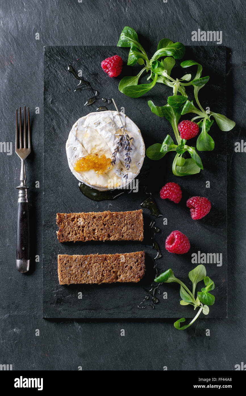 Goat cheese with honey and raspberries Stock Photo - Alamy