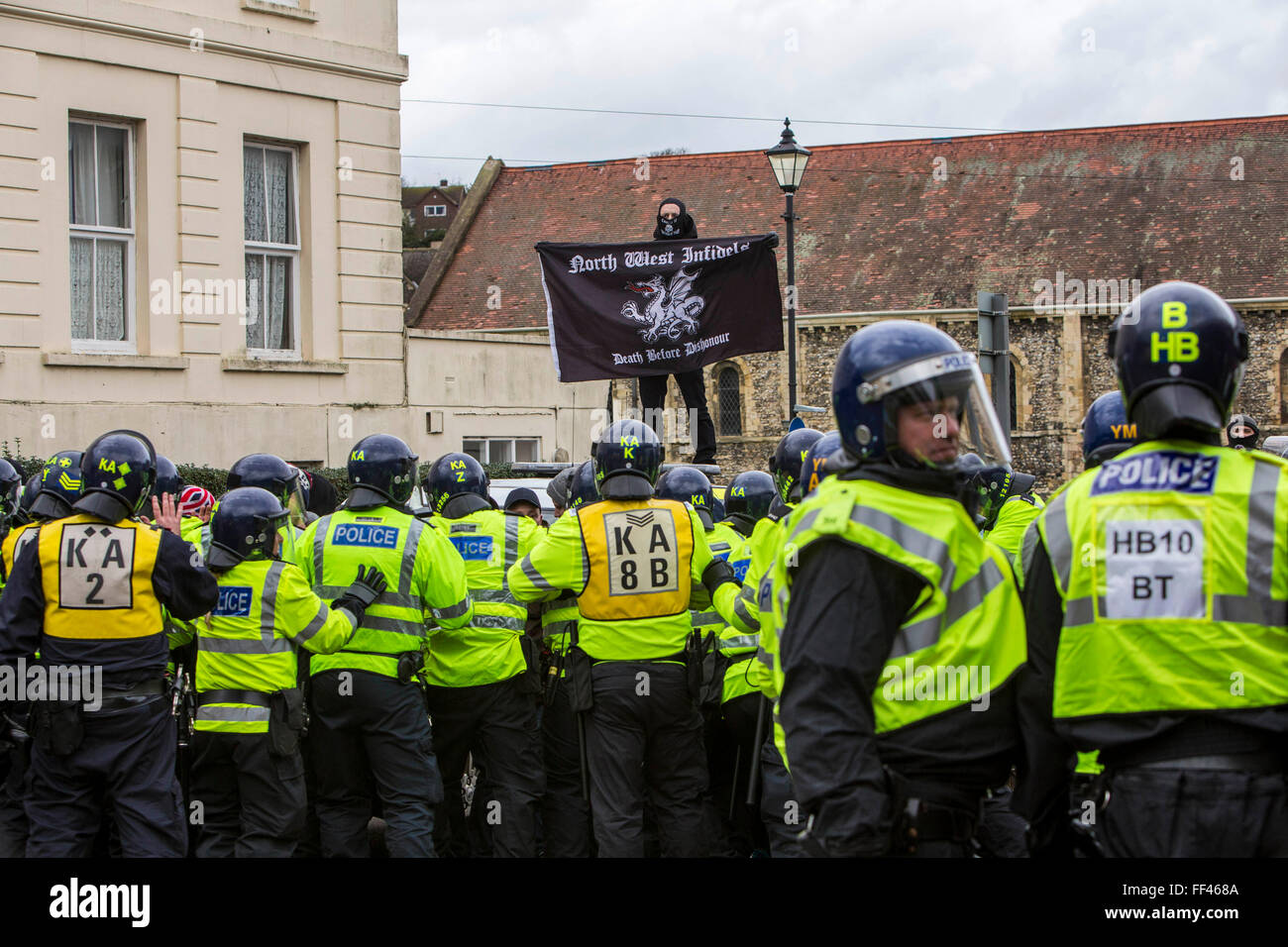 A lone Facist supporter stands high above police lines showing his ...