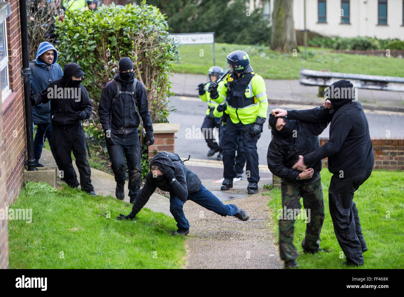 Police try to stop fights breaking out as two opposing groups meet on a ...