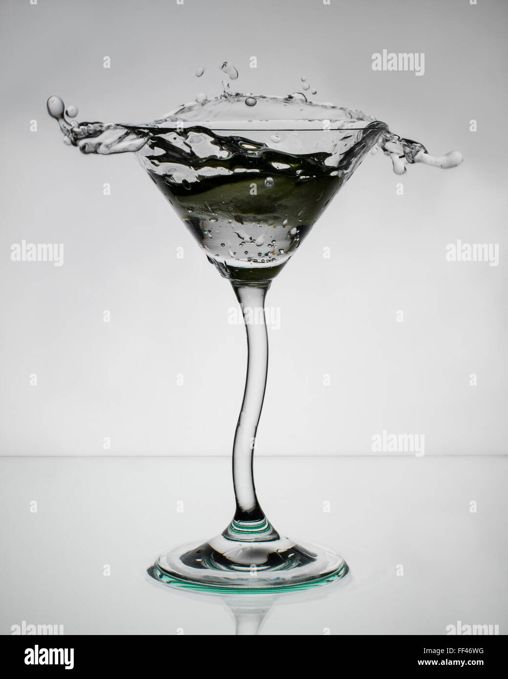 Glass with water splashing out Stock Photo - Alamy