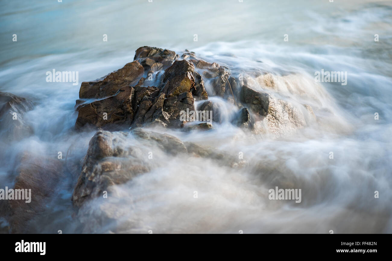 Abstract artwork of water cascading over an interesting rock formation ...