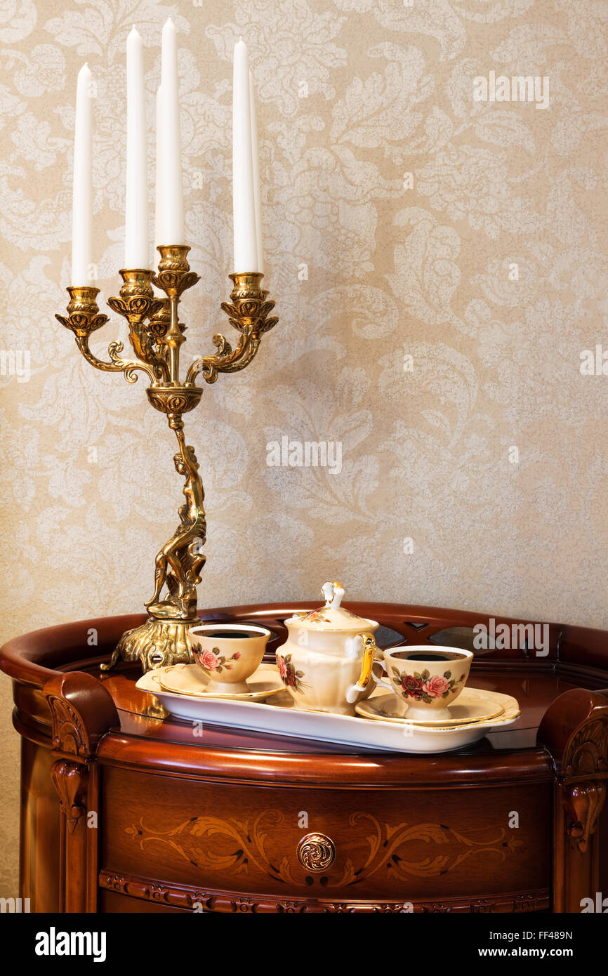 two cups of coffee and antique brass candlestick Stock Photo - Alamy