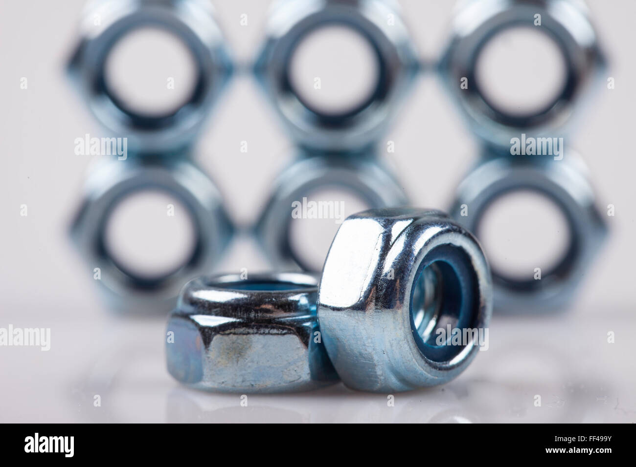 metal nuts closeup background Stock Photo - Alamy