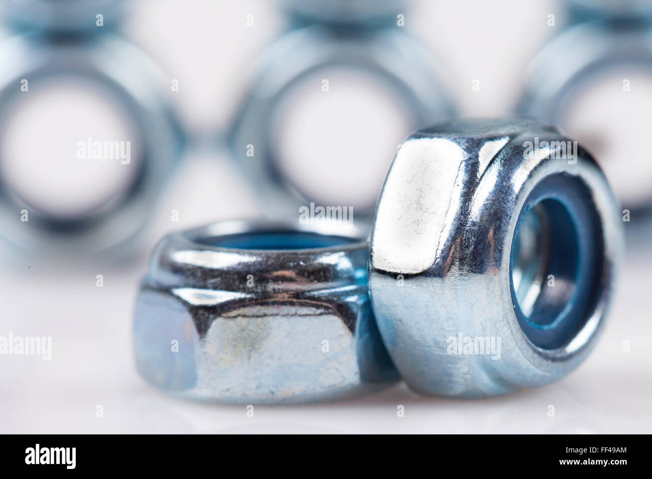 metal nuts closeup on white background Stock Photo - Alamy