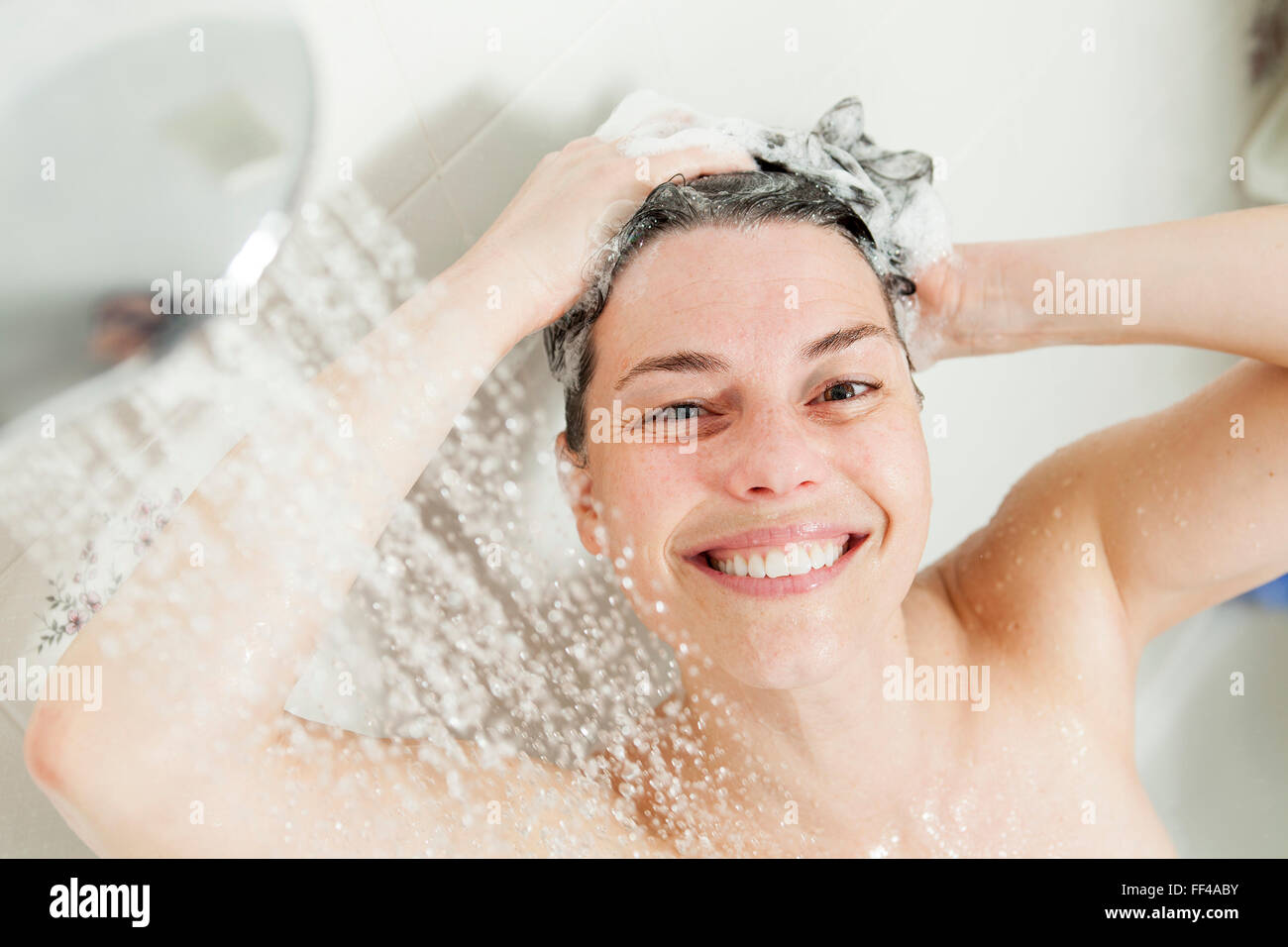 Shower woman. Happy smiling woman washing shoulder showering in Stock ...