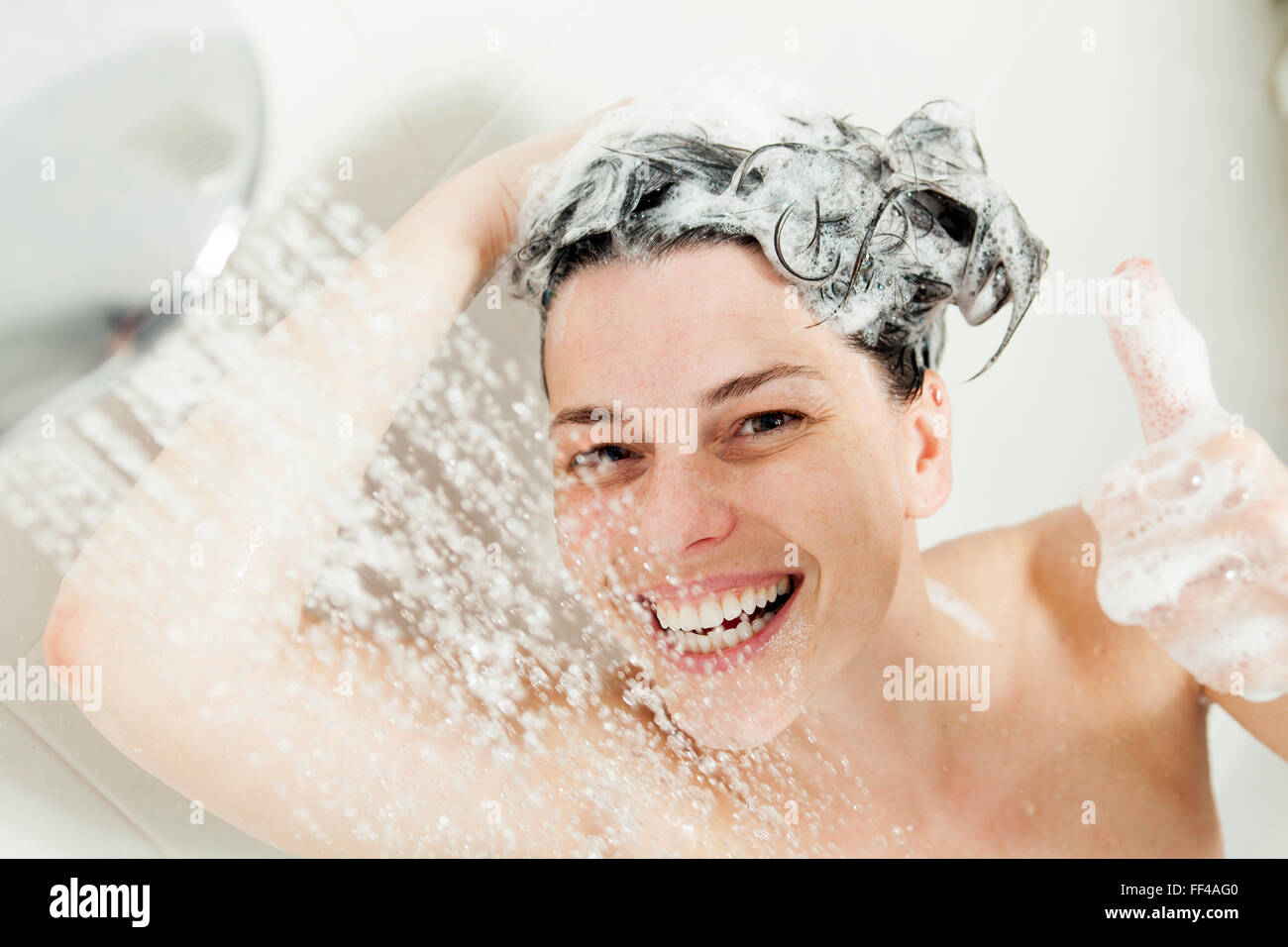 Shower woman. Happy smiling woman washing shoulder showering in Stock ...