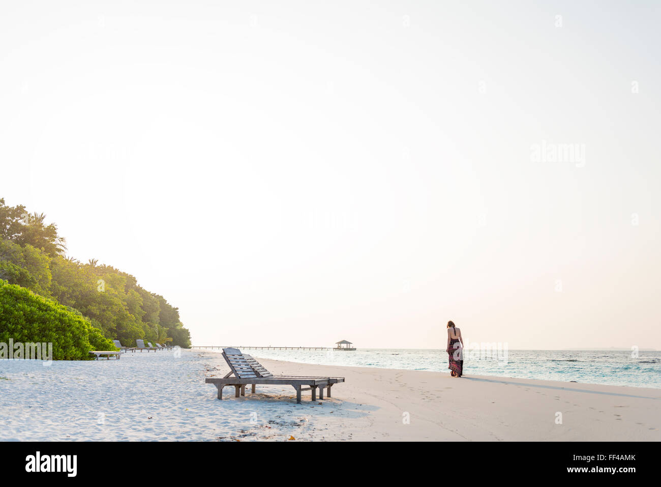 sunrise at a lonely beach with beautiful woman walking past. lonely ...