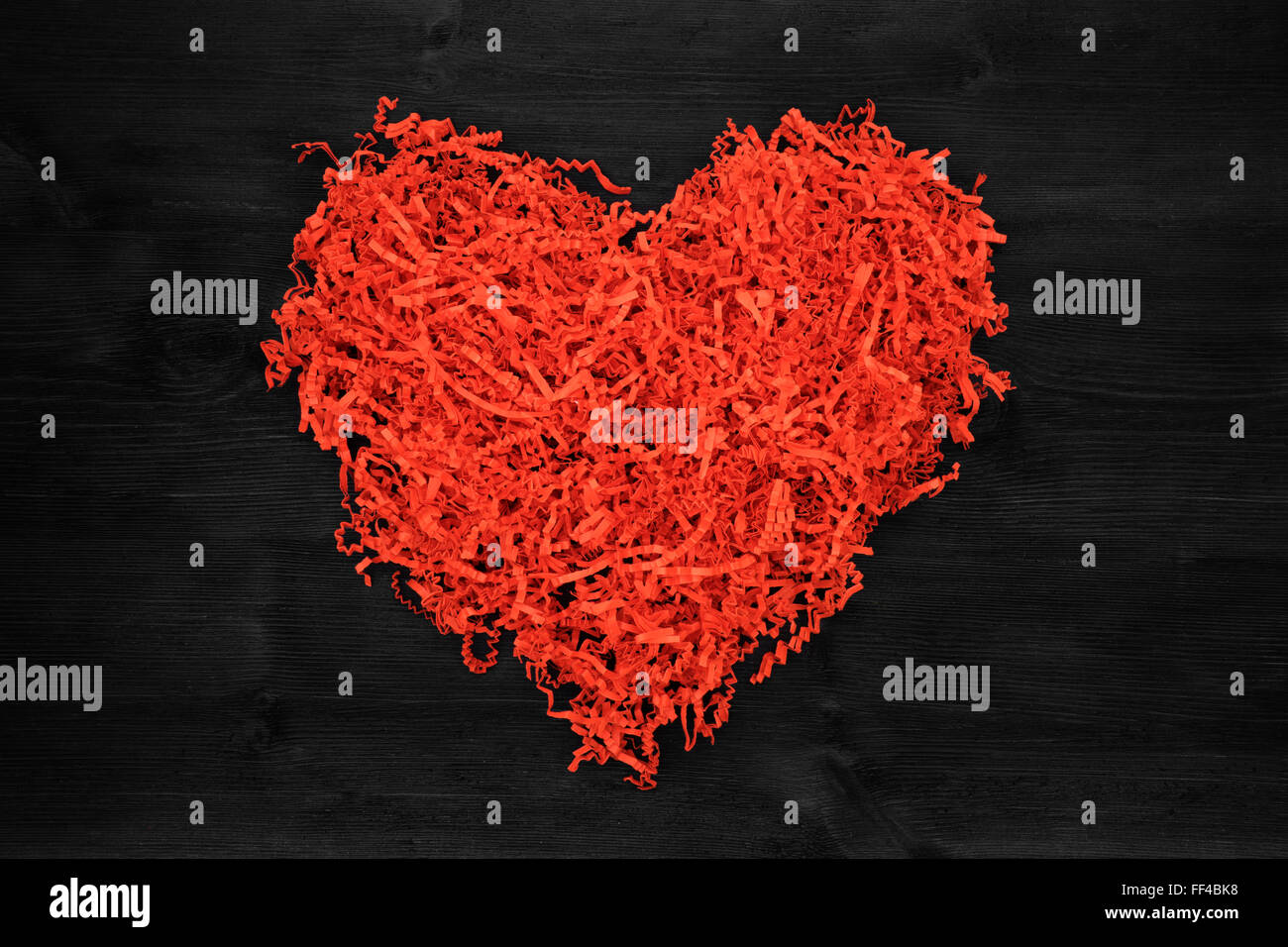 Big red heart isolated on black background Stock Photo - Alamy